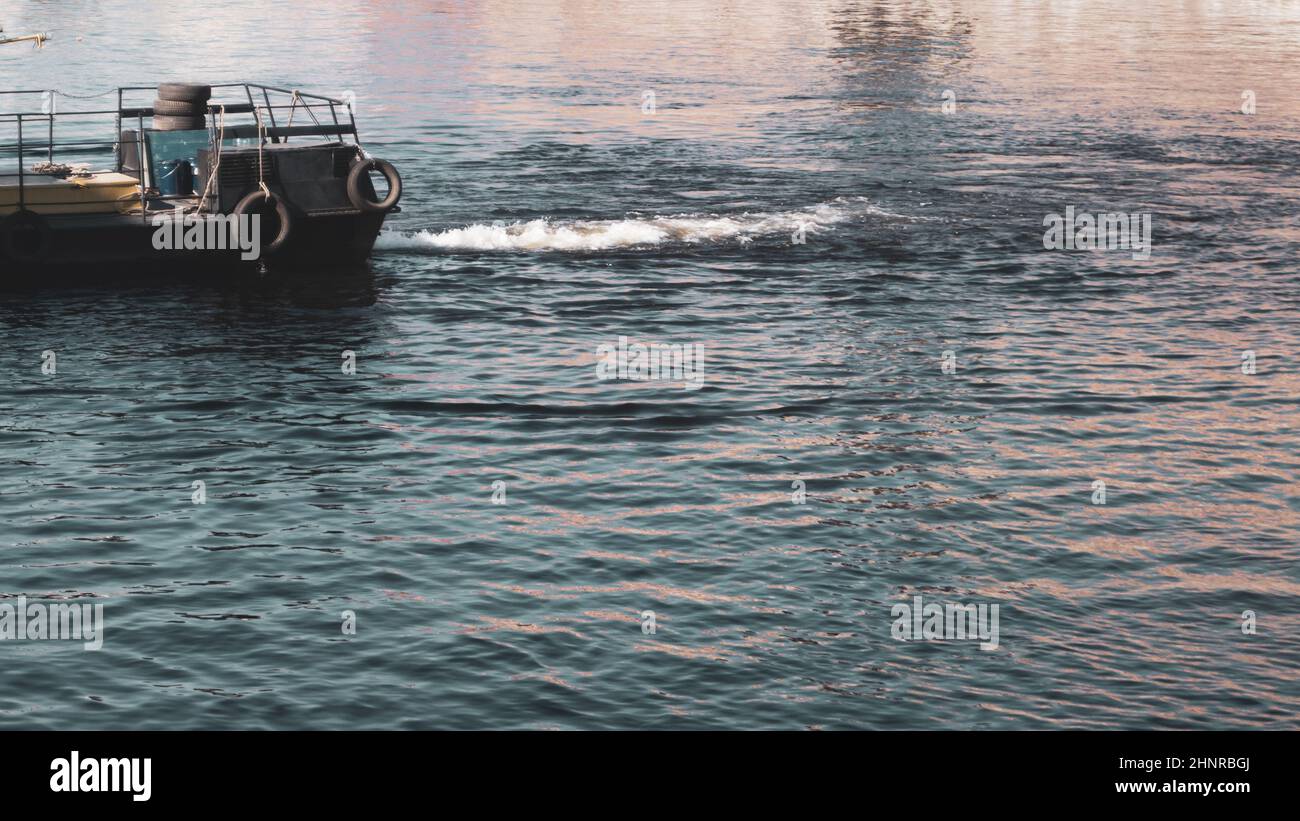 Water surface with ripples and part of a ship. abstract background ...