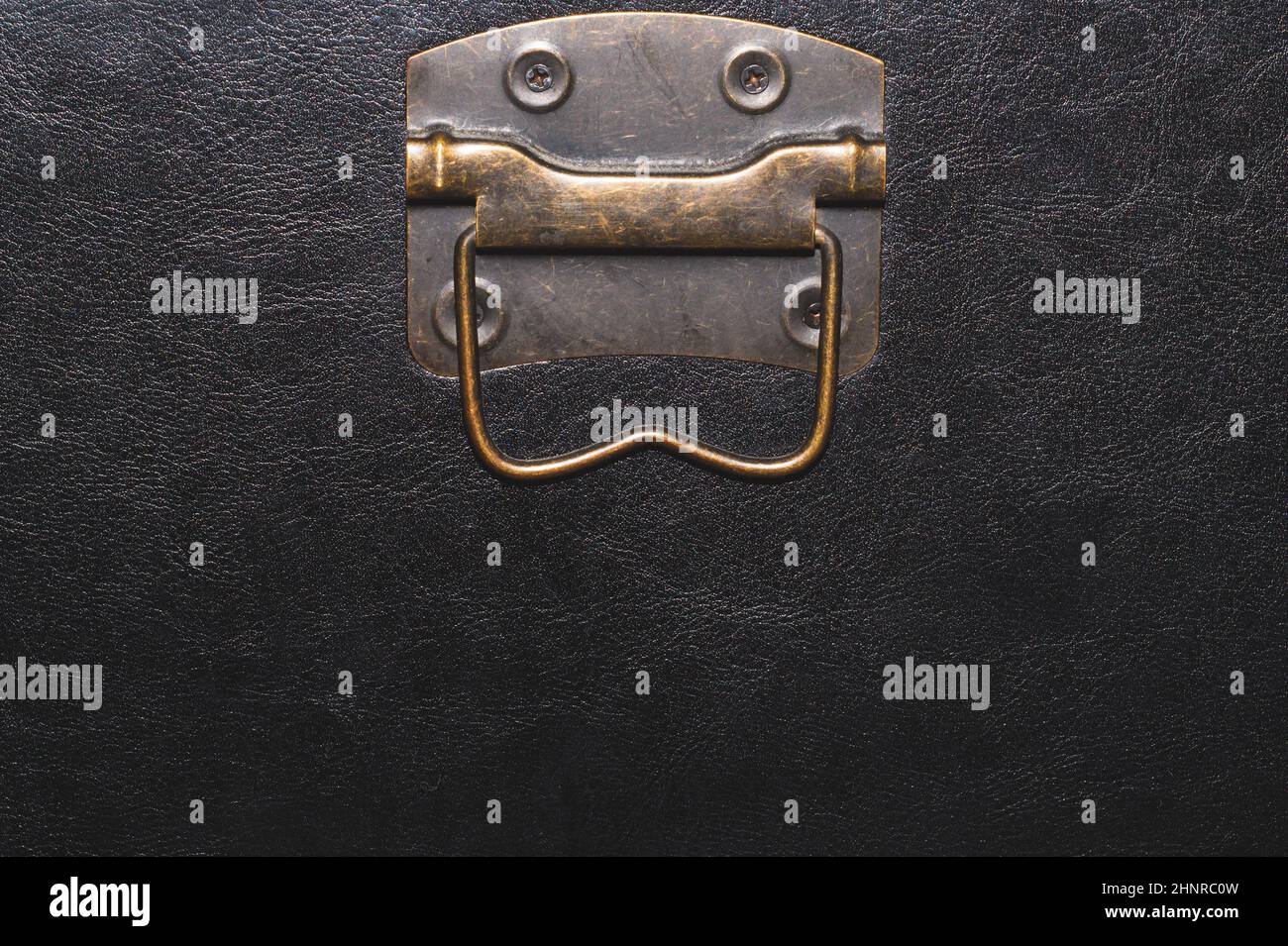Metal handle with black leather background Stock Photo - Alamy