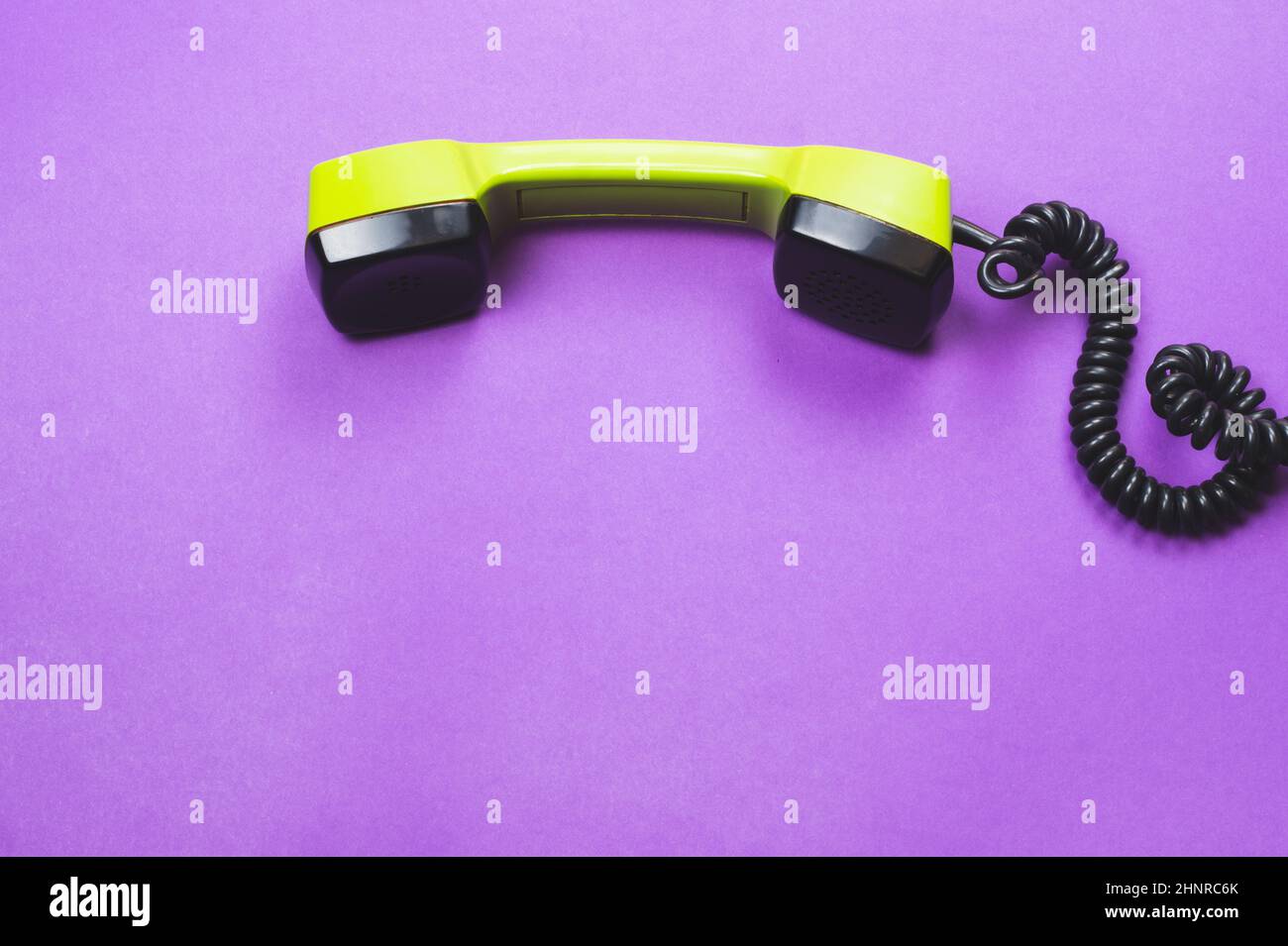 Vintage green telephone handset. phone receiver isolated on purple ...