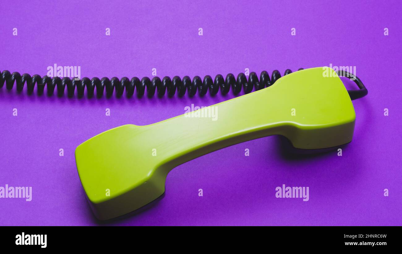 Vintage green telephone handset. phone receiver isolated on purple ...