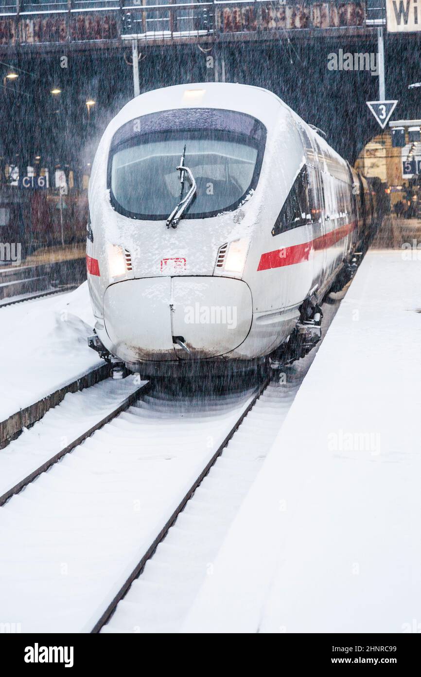 snowfall at the train station in Wiesbaden with high speed train ice ...