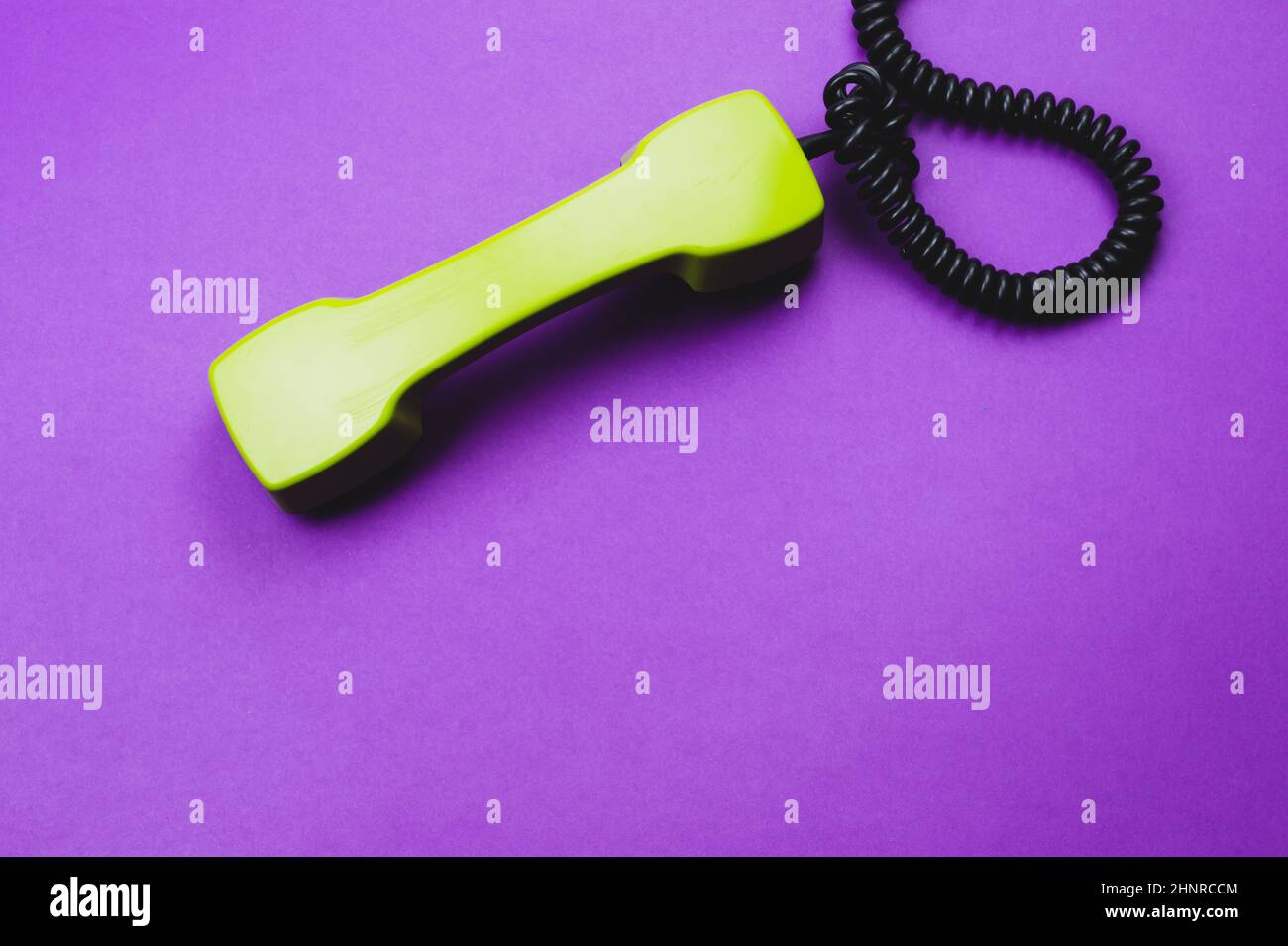 Vintage green telephone handset. phone receiver isolated on purple ...