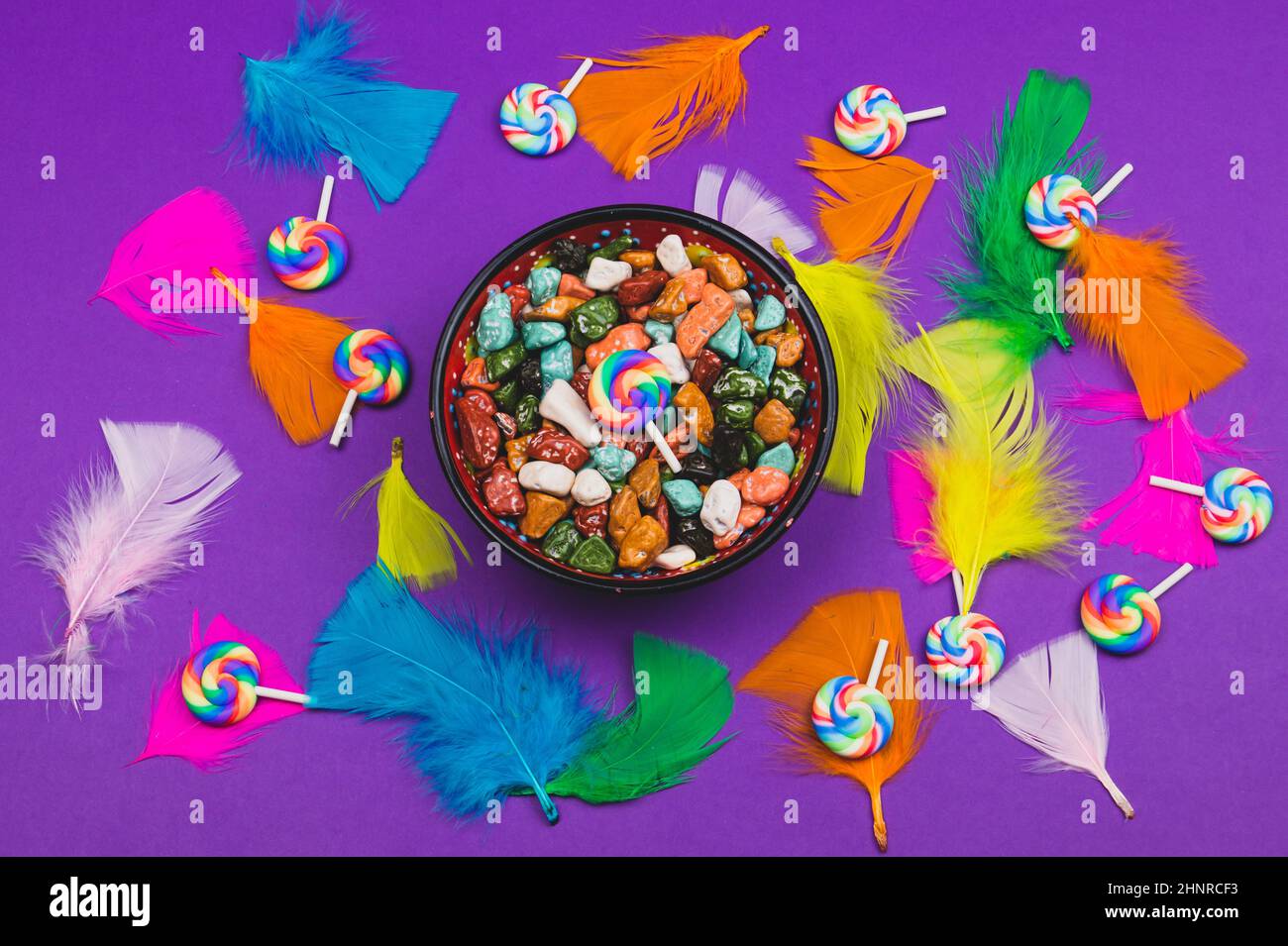 Candy pebbles in a bowl and lollipops. spiral candies and sweets in the ...
