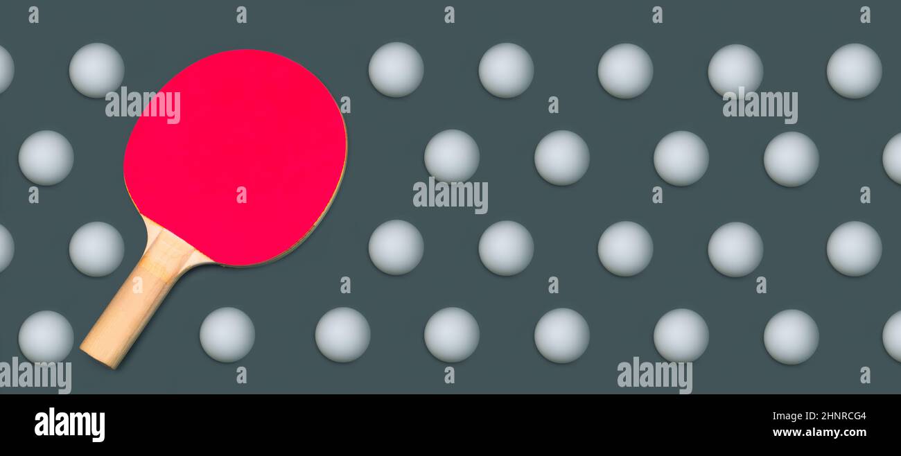 Red table tennis racket with many balls arranged symmetrically on a ...