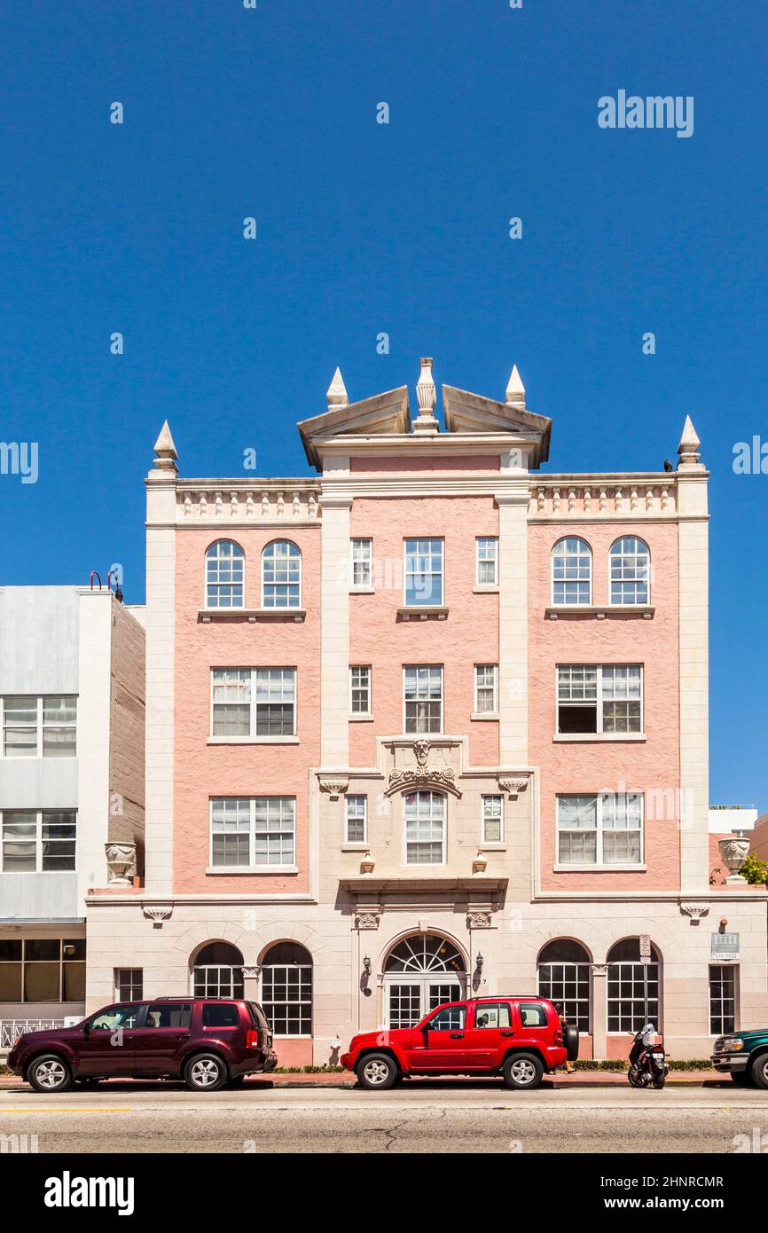 art deco building with parking cars in midday heat at Ocean drive in ...