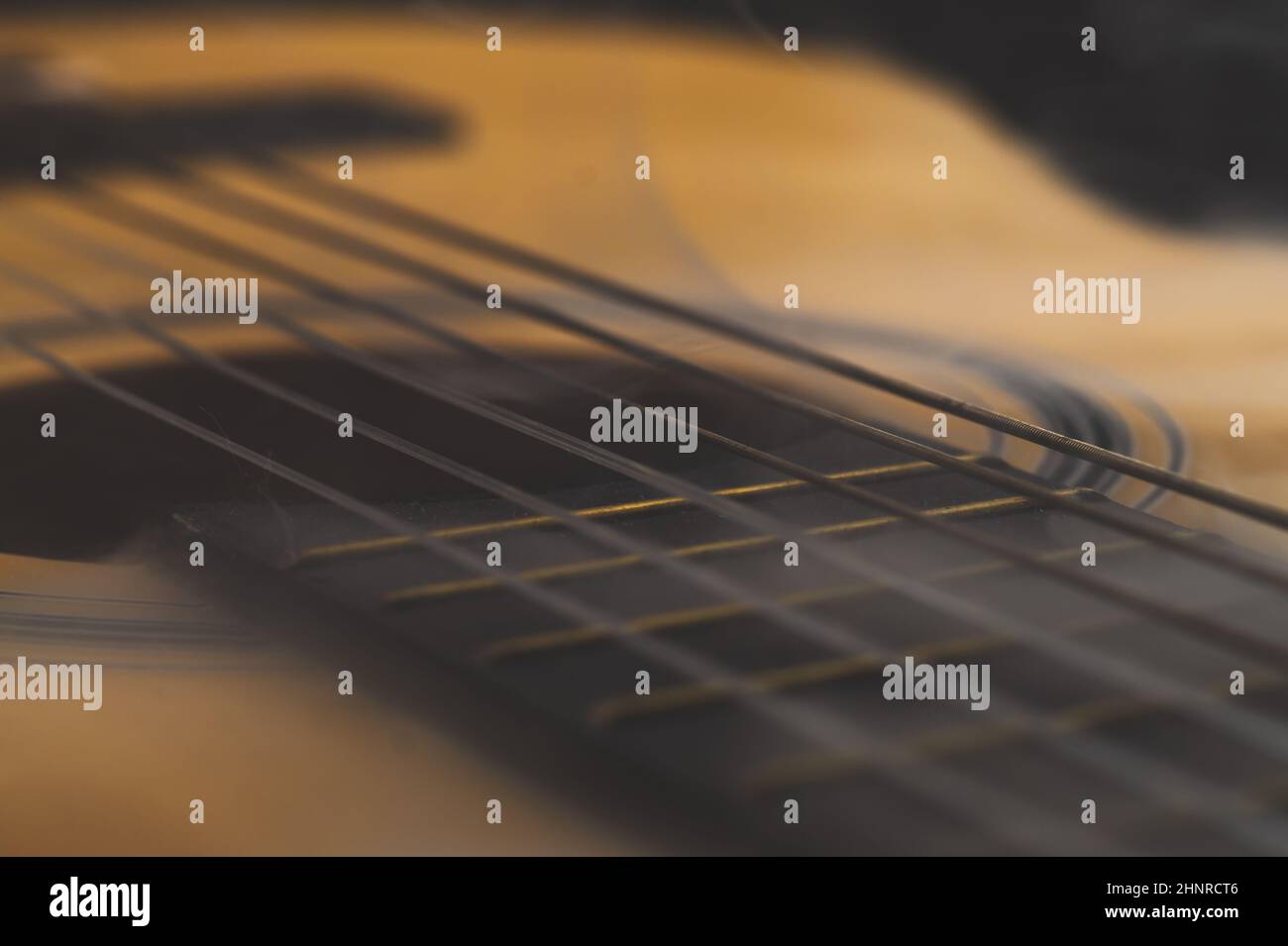 Acoustic guitar in smoke close up. musical instrument. strings on the ...