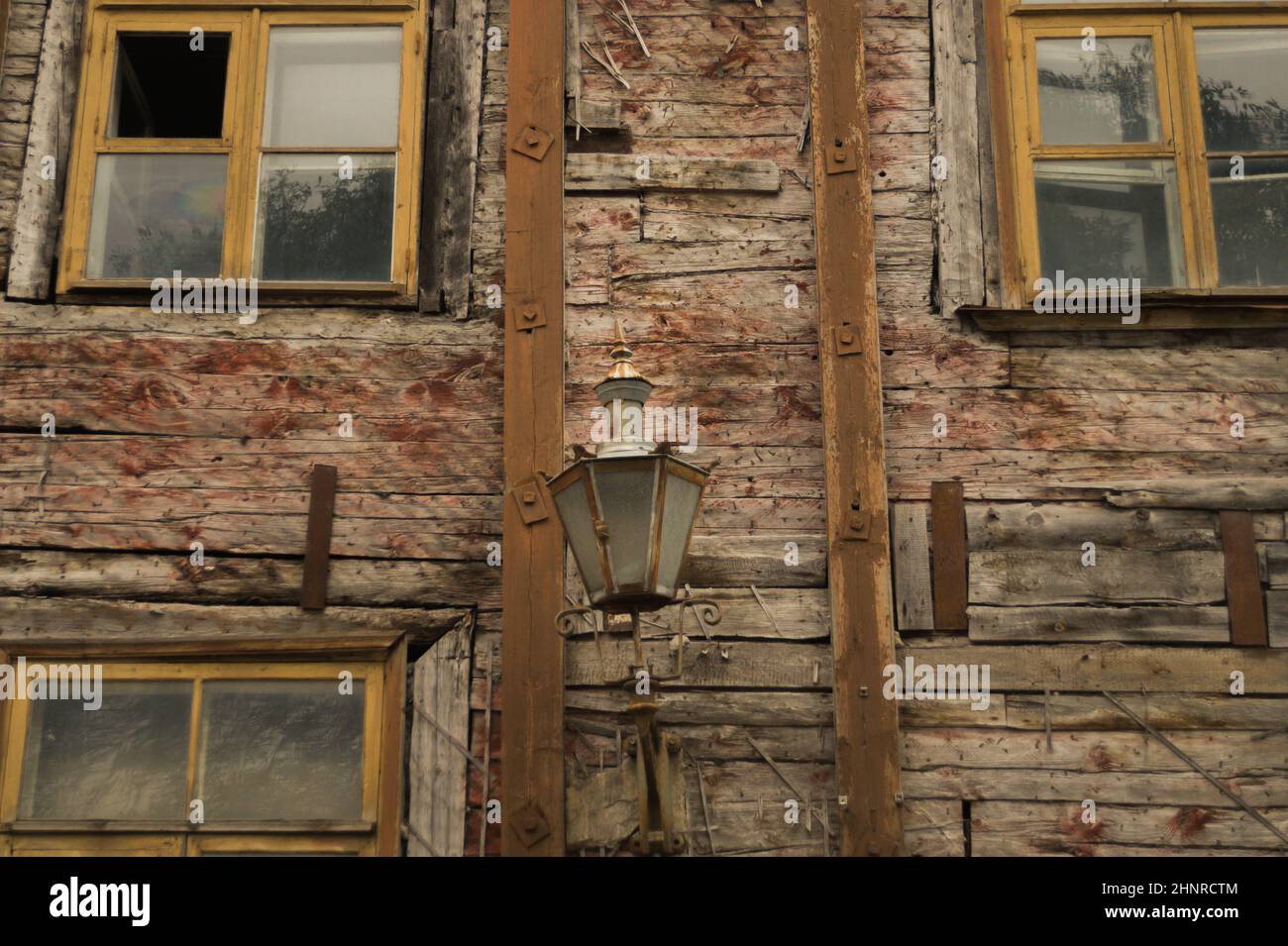 Windows of the old wooden house. wooden plank wall with windows and ...
