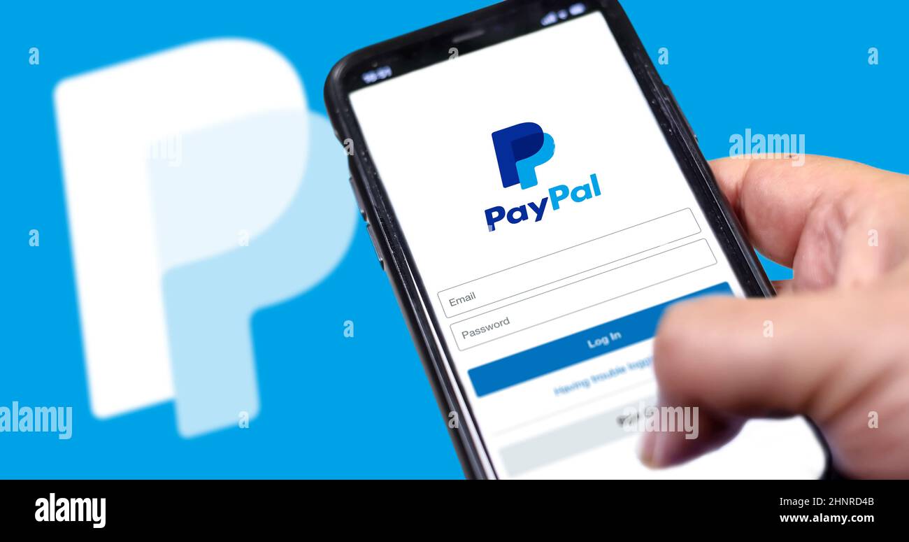 Hand holding a smart phone with Paypal app login page on screen Stock ...