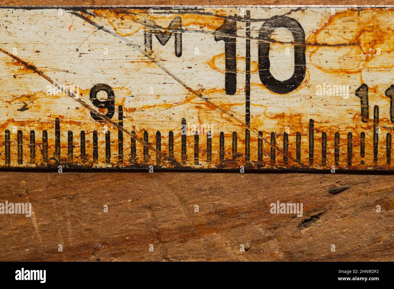 Old rusty ruler with black numbers on a working wooden table. vintage ...