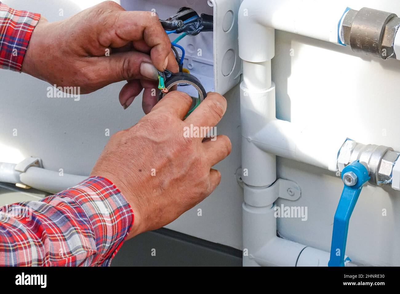 Electrician repair power cable for water pump control at home site ...