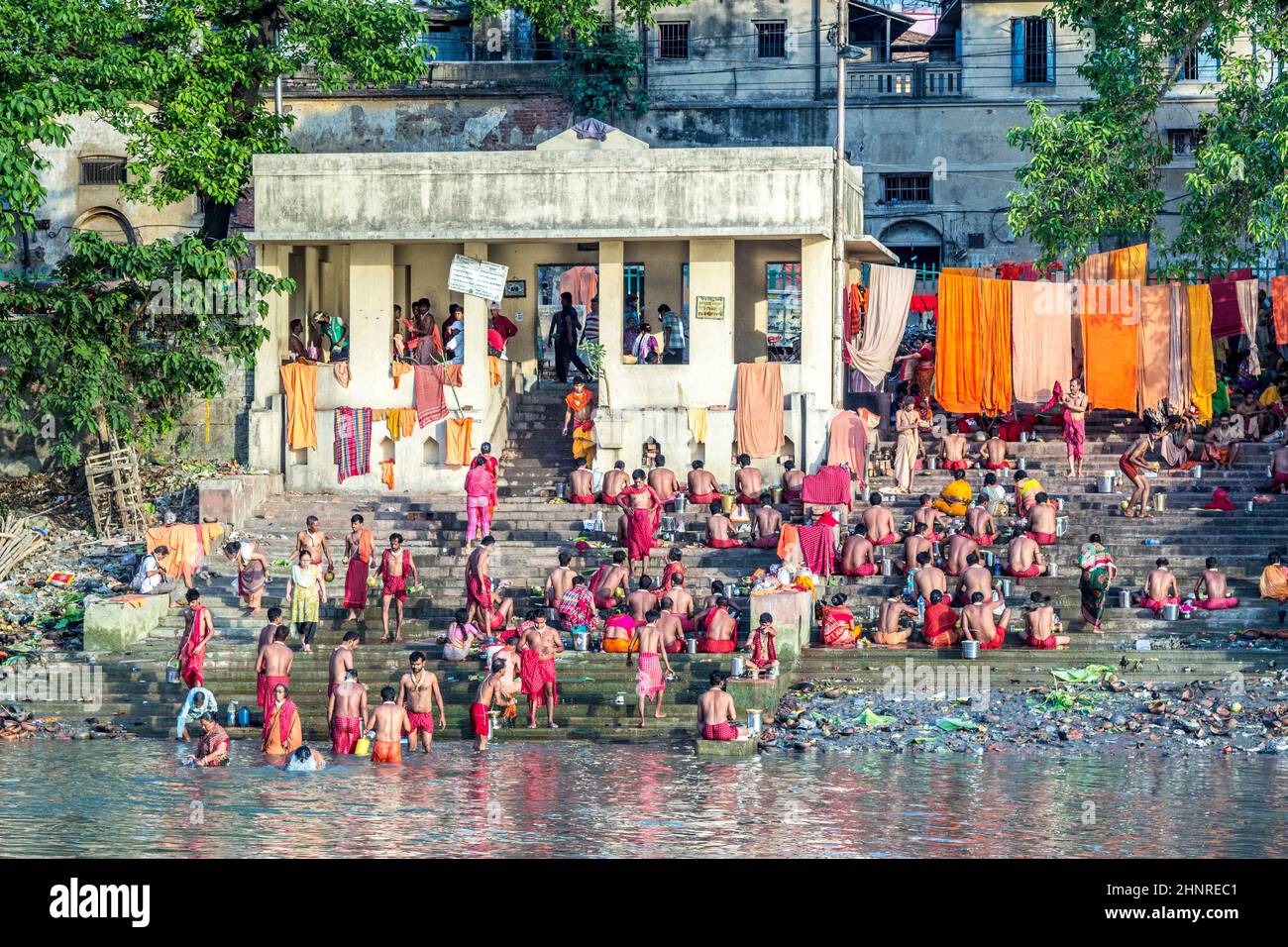 people cleaning clothes and washing in the river Ganges in Calcutta ...