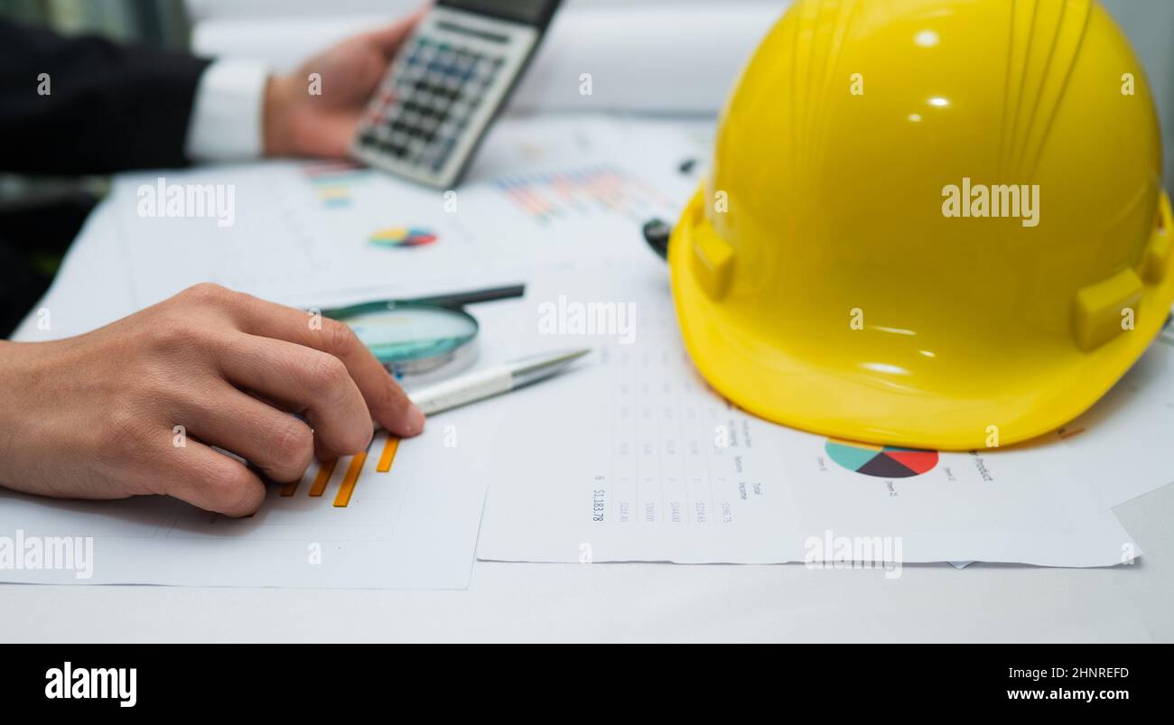 Architect or engineer working project accounting with graph and ...