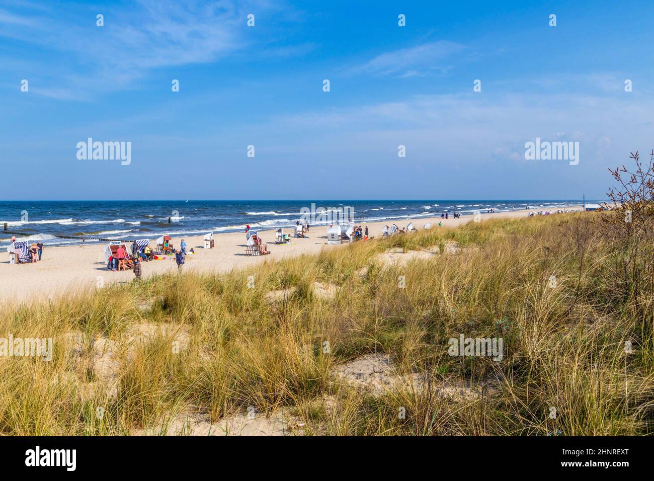 people at the beach in the roofed wicker beach chair Stock Photo - Alamy
