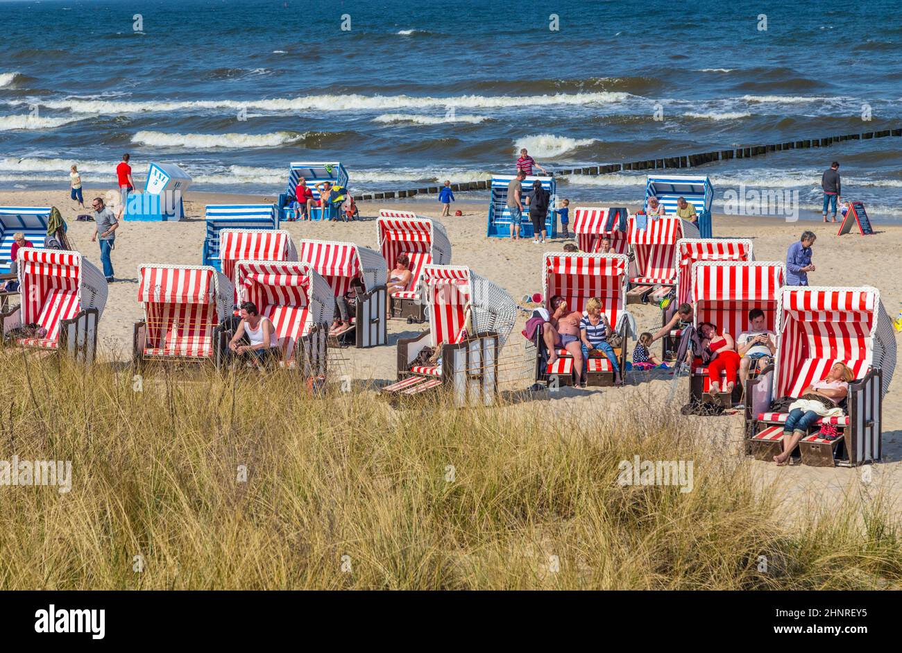 people at the beach in the roofed wicker beach chair Stock Photo - Alamy