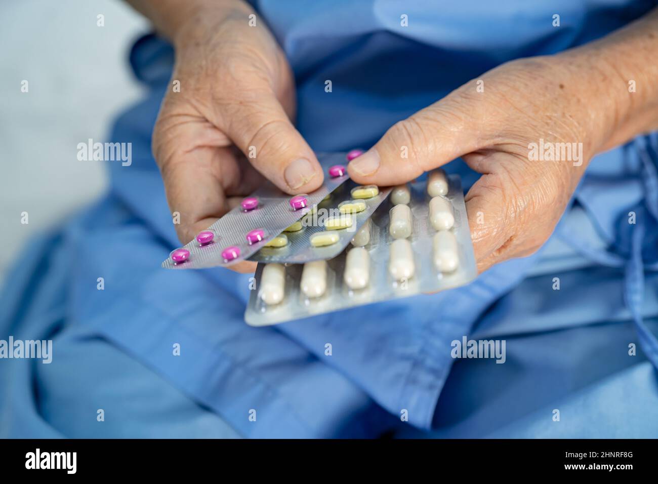 Asian senior or elderly old lady woman patient holding antibiotics ...