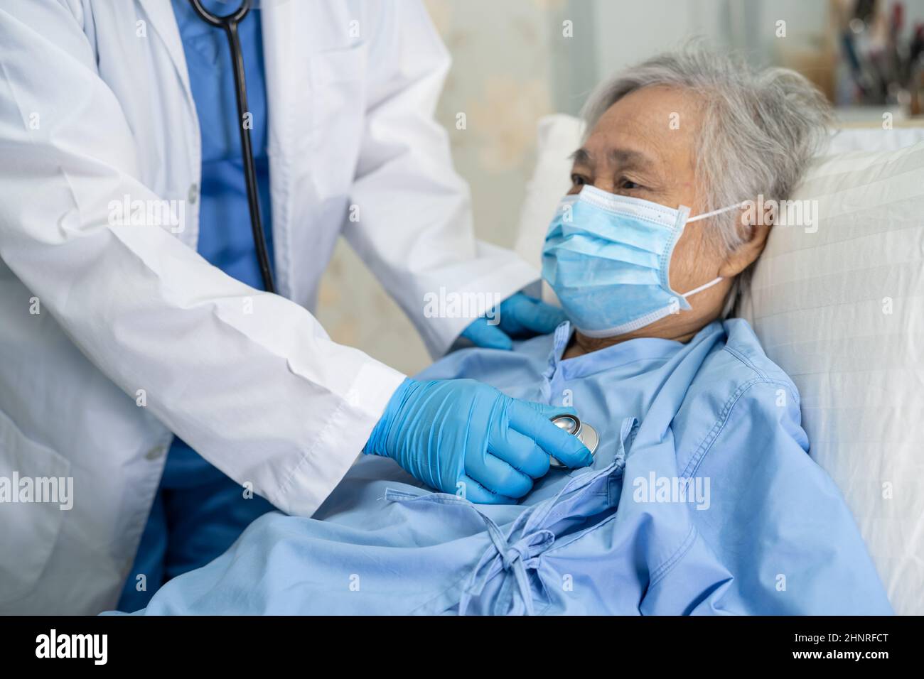 Doctor using stethoscope to checking Asian senior or elderly old lady ...