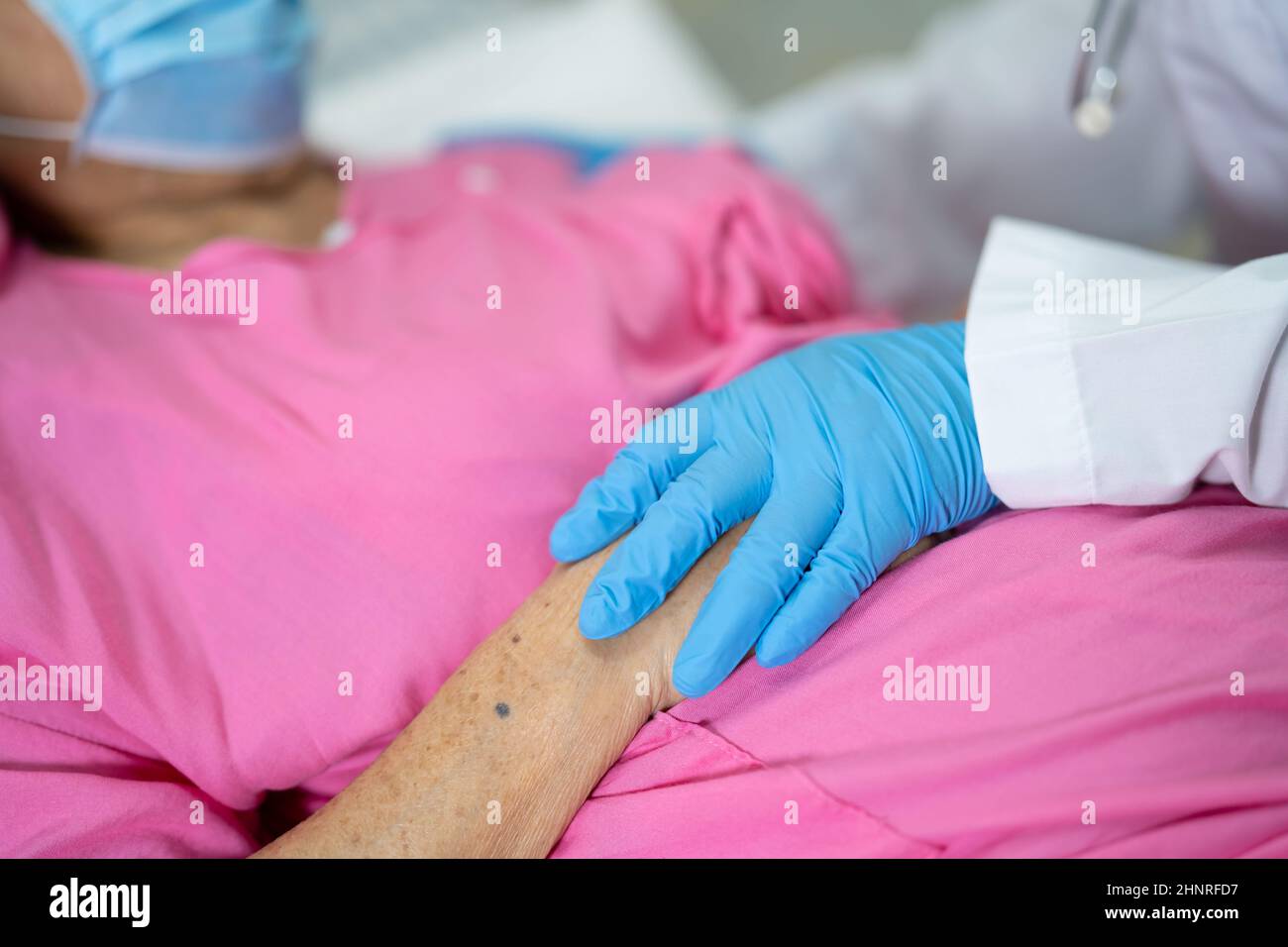 Asian doctor wearing PPE suit new normal to check patient with mask ...