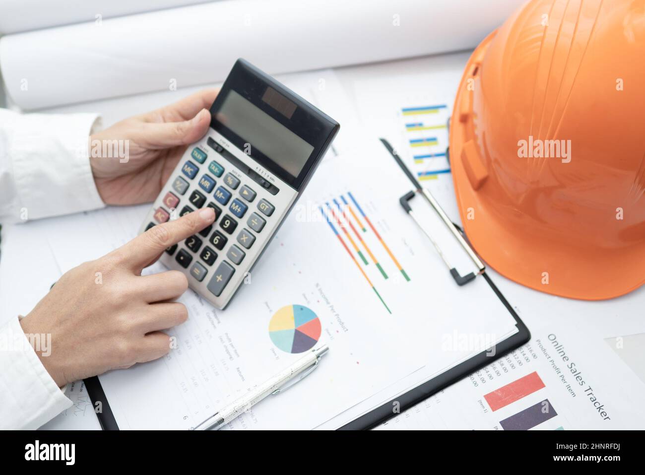 Architect or engineer working project accounting with graph and ...