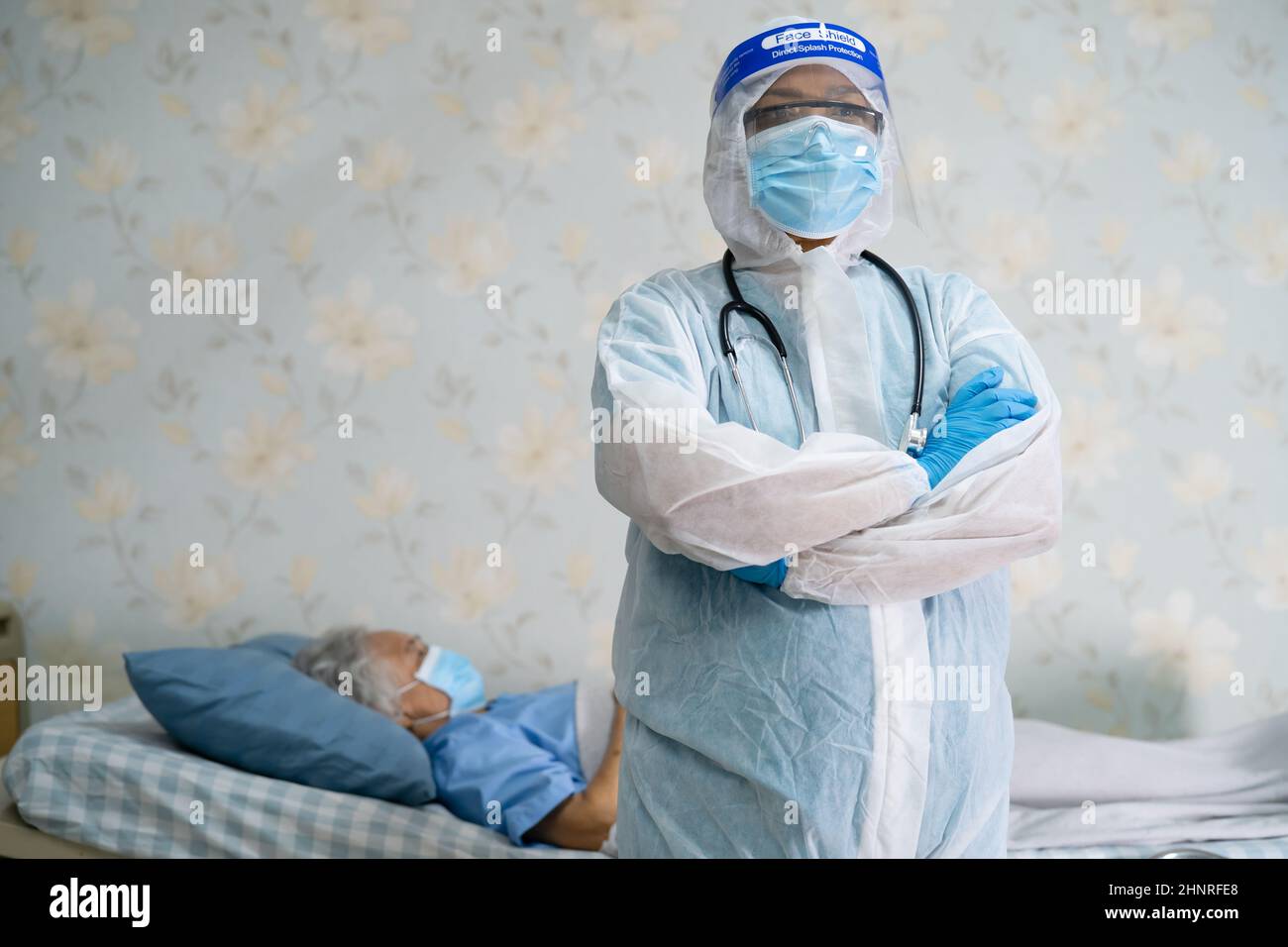 Asian doctor wearing face shield and PPE suit new normal to check ...