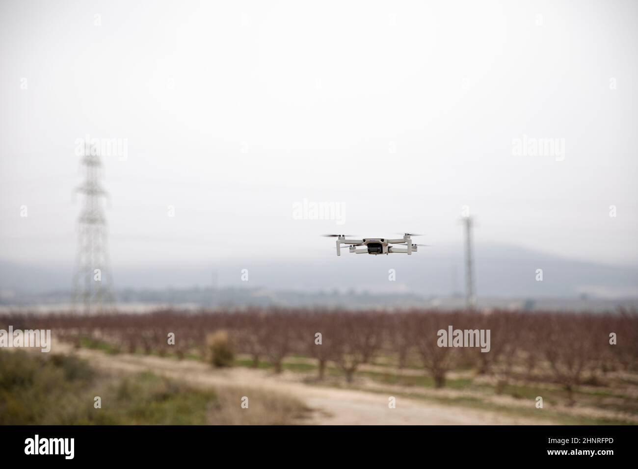 Modern drone flying freely in a field in nature Stock Photo - Alamy