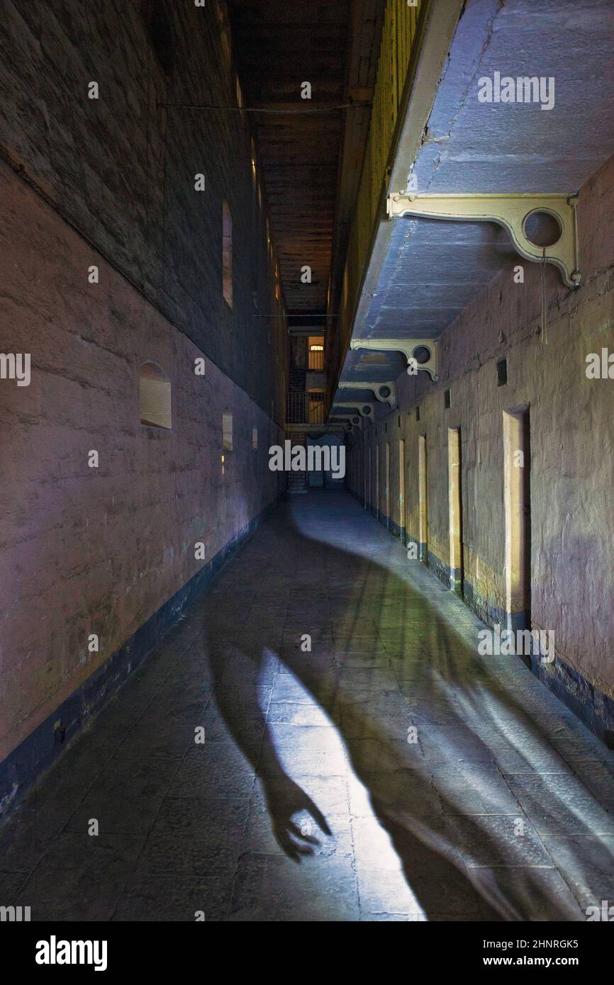 A Ghostly Shadow along a Haunted Prison Cell Block Stock Photo - Alamy