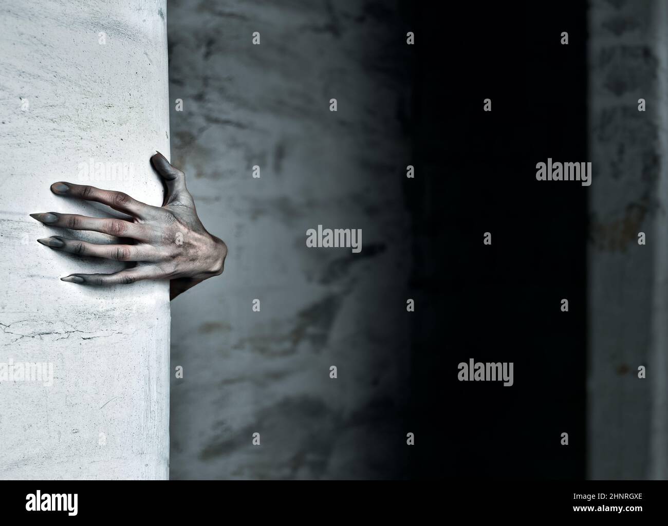 A Scary Hand Reaches out from Behind a Wall Stock Photo - Alamy