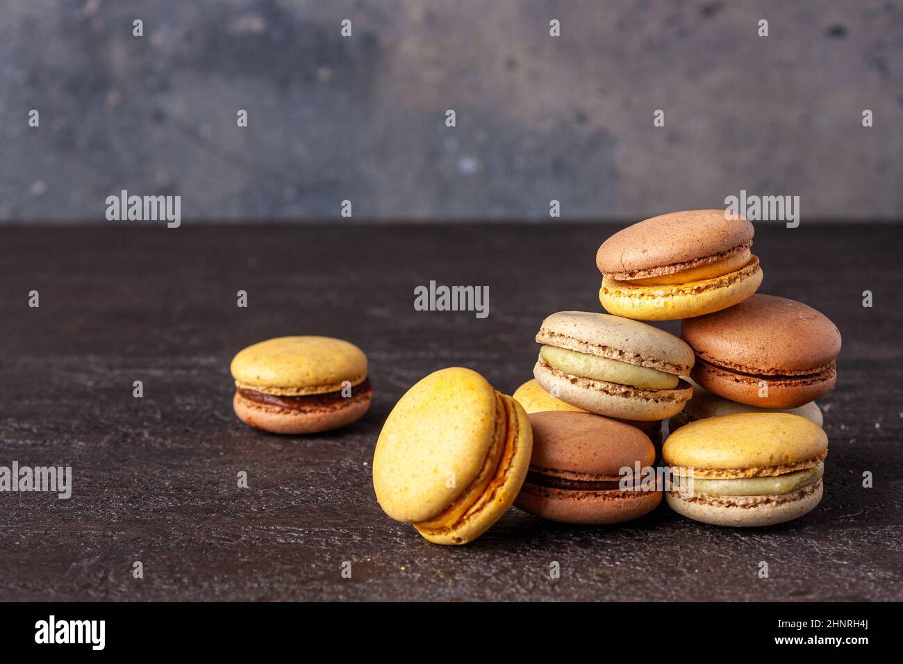 french macaroon dessert lie on brown texture background, copy sp Stock ...