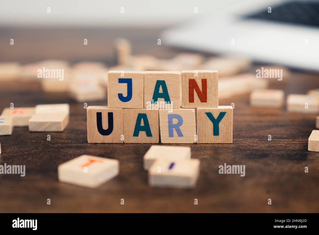 The name of the month January written on wooden cubes od the tabletop ...