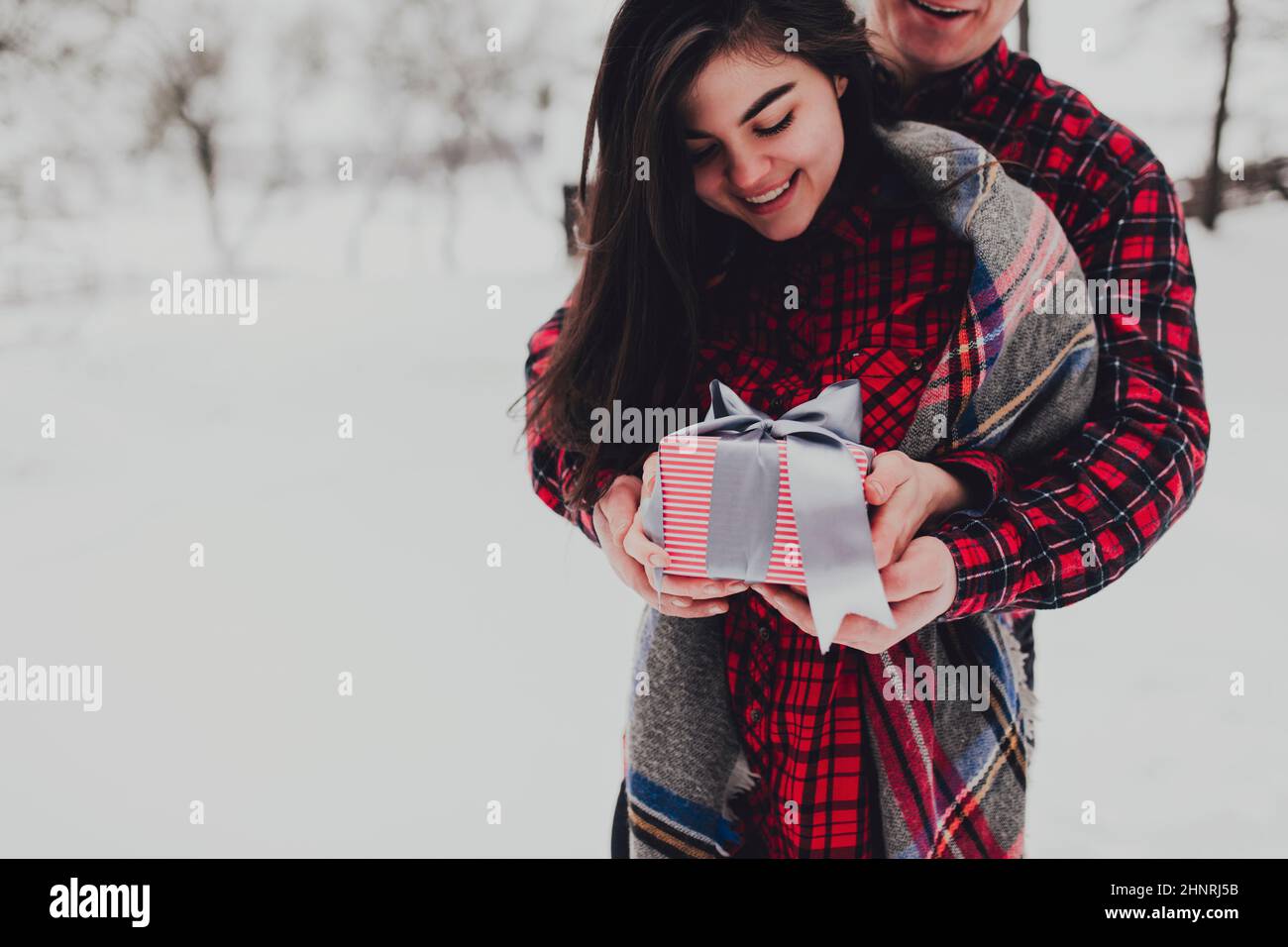Boyfriend giving a gift box present with ribbon due to Saint Valentine ...