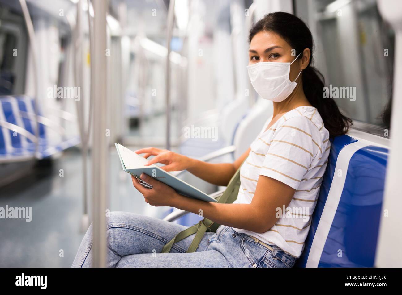 Asian woman reading book train hi-res stock photography and images - Alamy