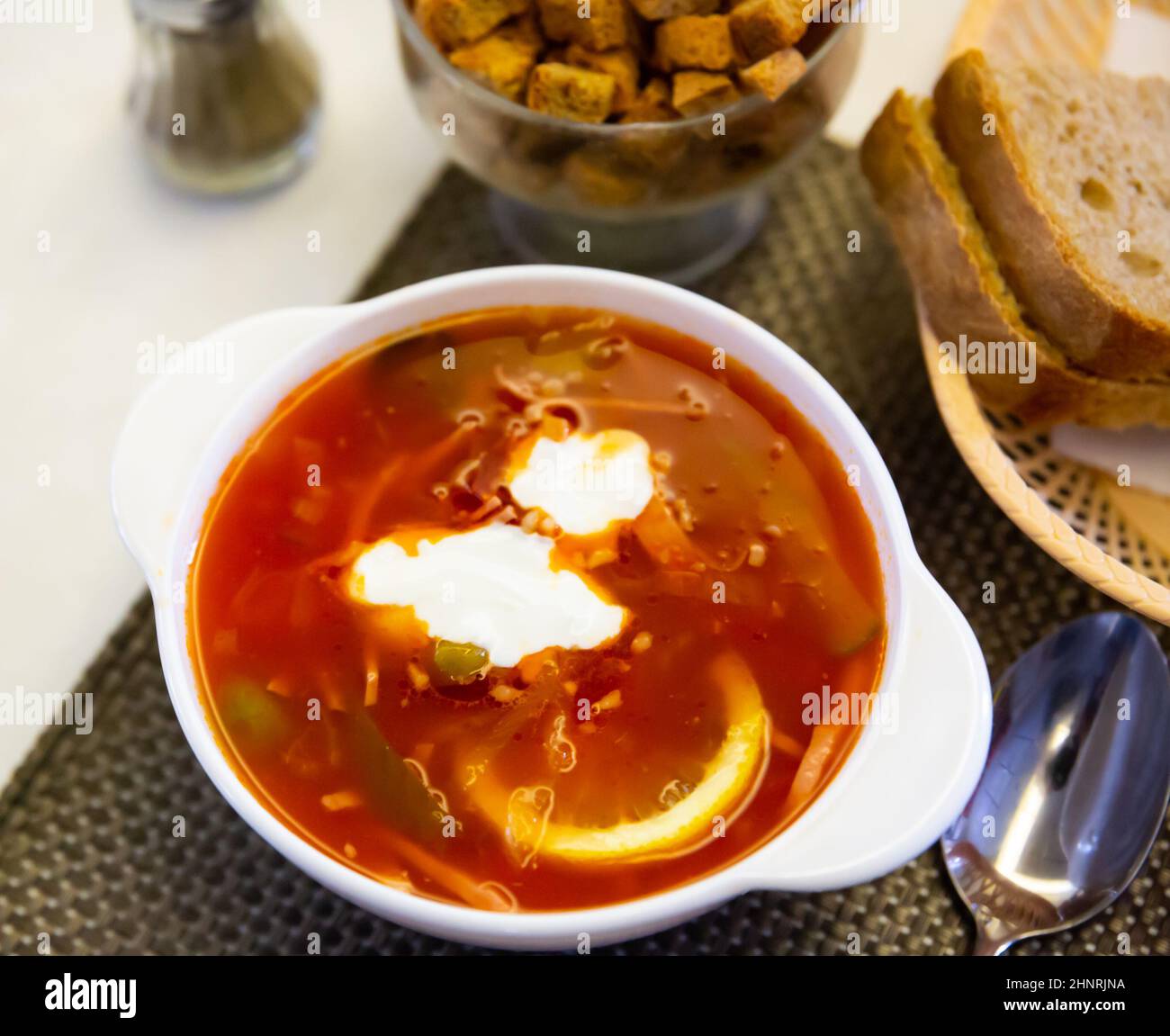 Traditional Russian meat soup Solyanka with sour cream and lemon Stock ...