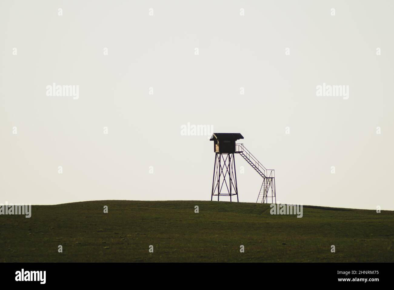 Lonely watch tower. observation post standing alone on the hill ...