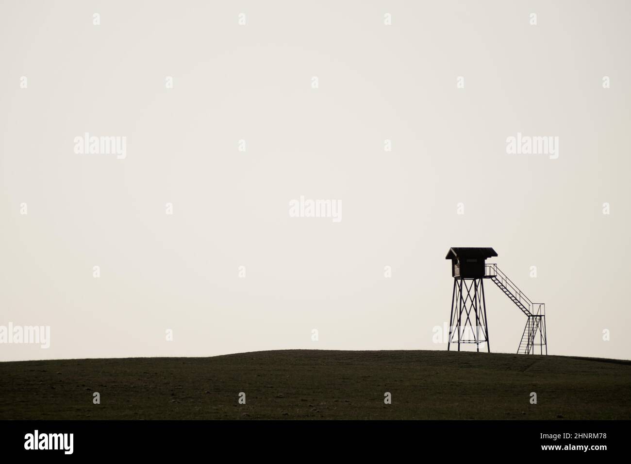 Lonely watch tower. observation post standing alone on the hill ...