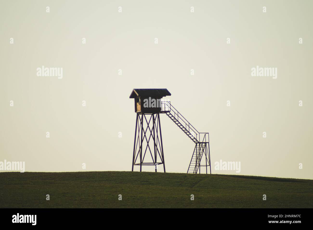 Lonely watch tower. observation post standing alone on the hill ...
