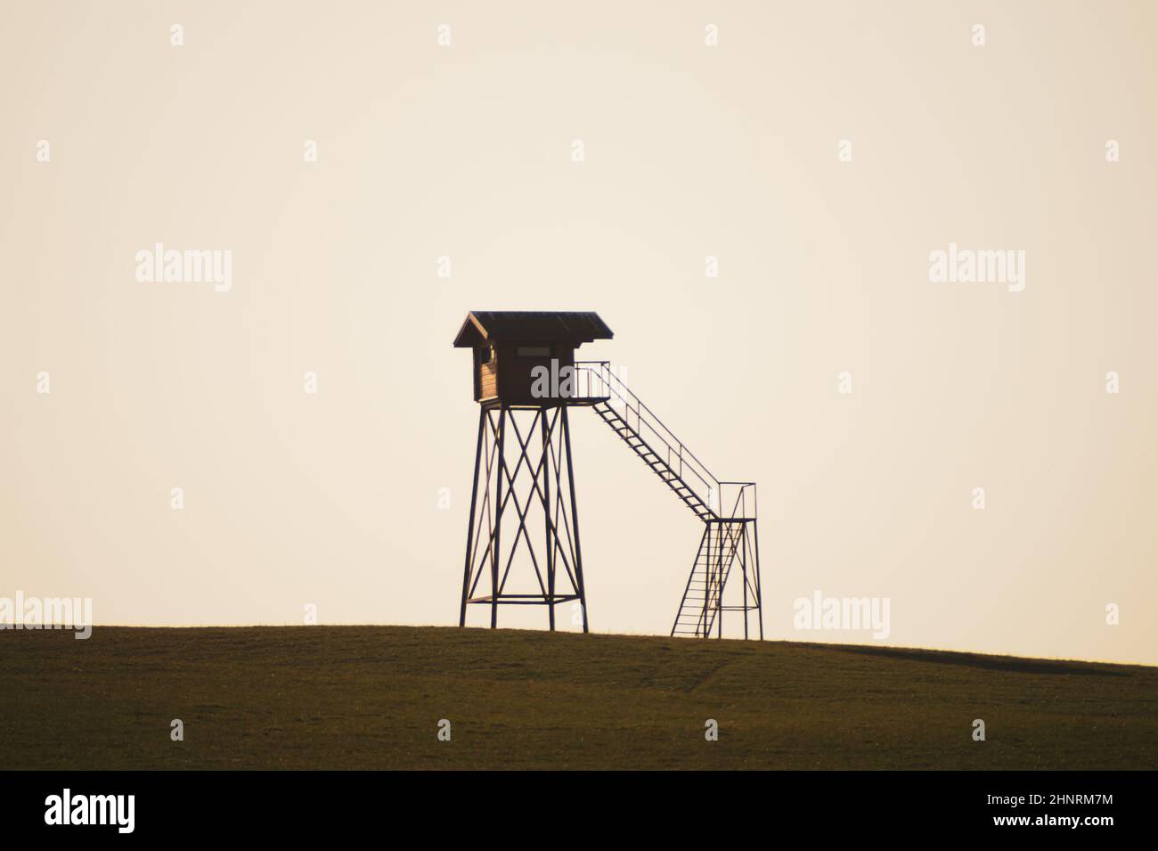 Lonely watch tower. observation post standing alone on the hill ...