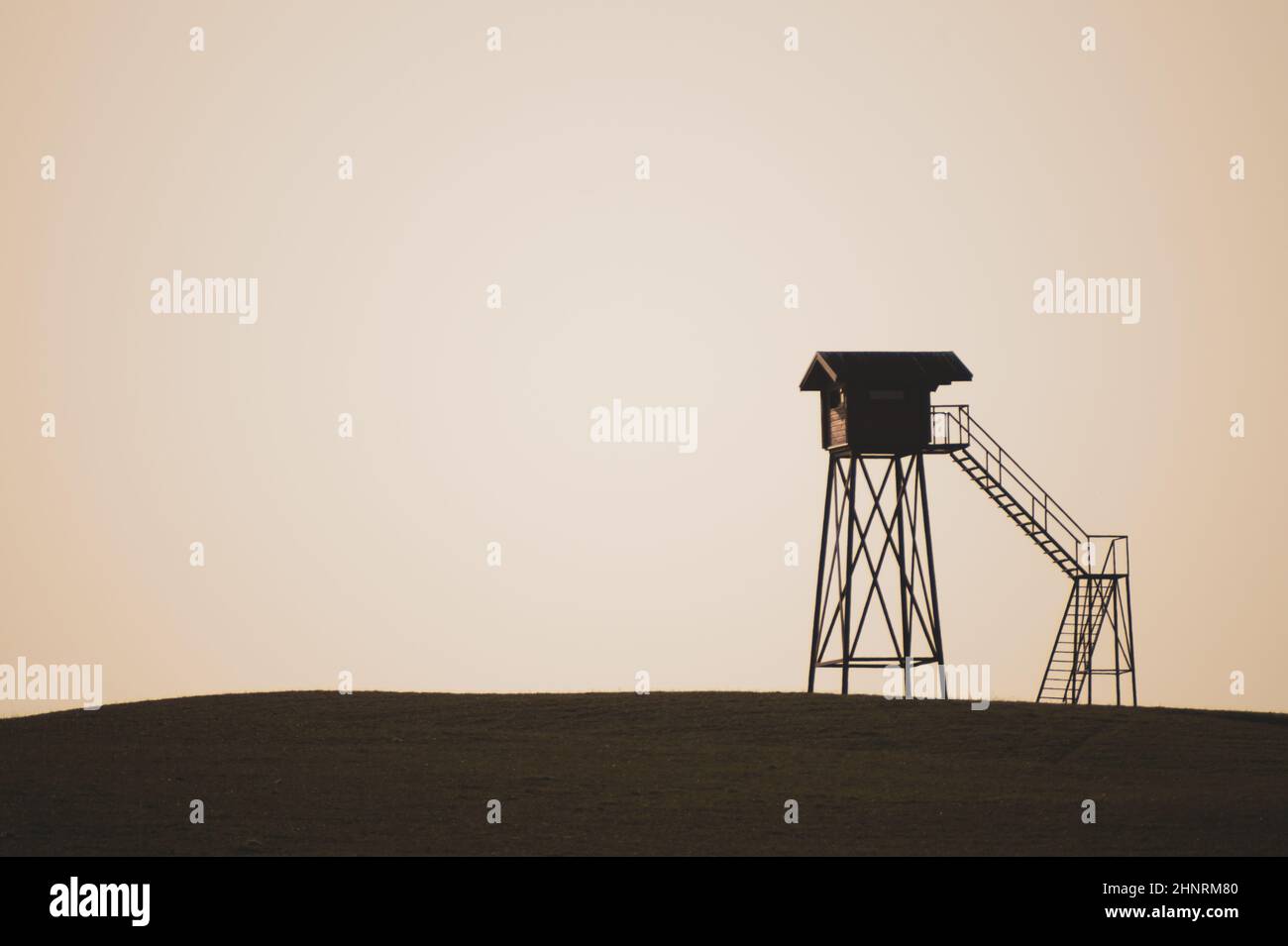 Lonely watch tower. observation post standing alone on the hill ...