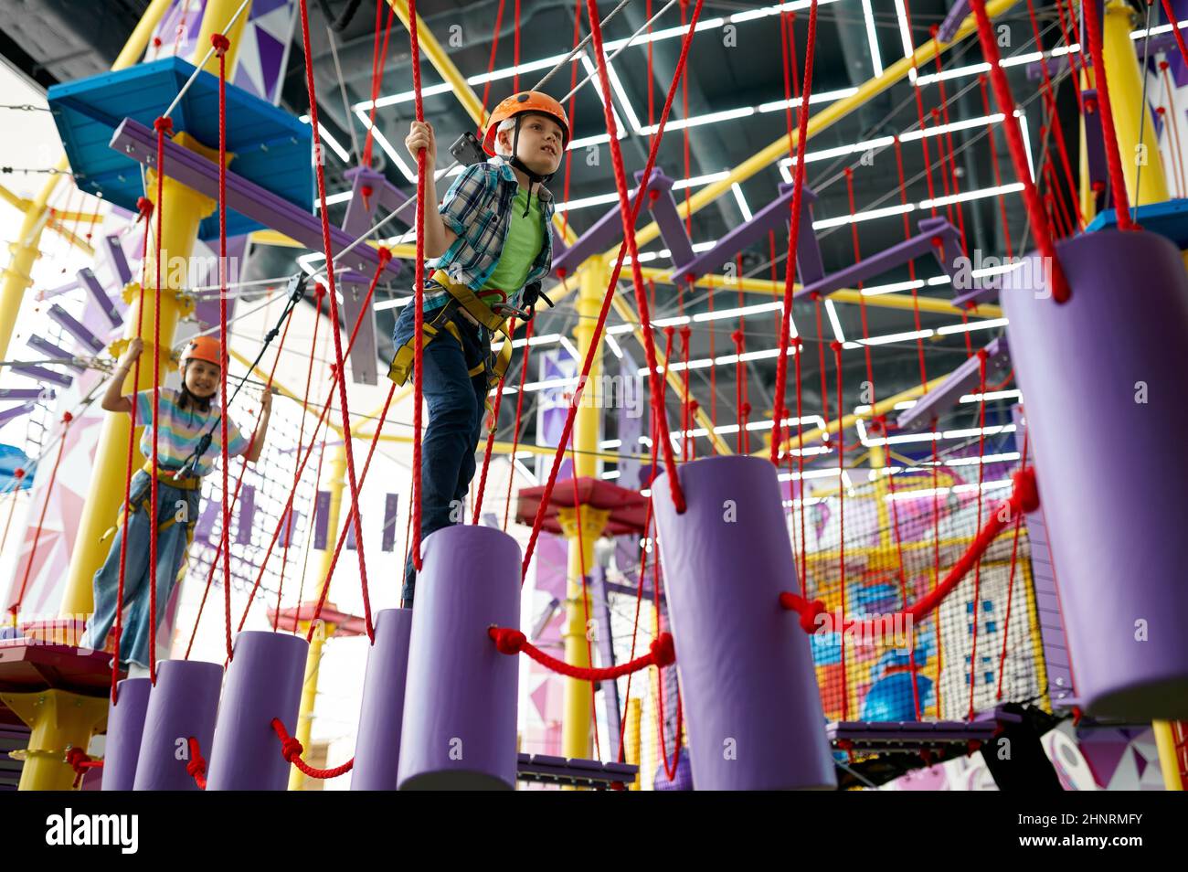 Children climb on zip line in entertainment center, little climbers ...