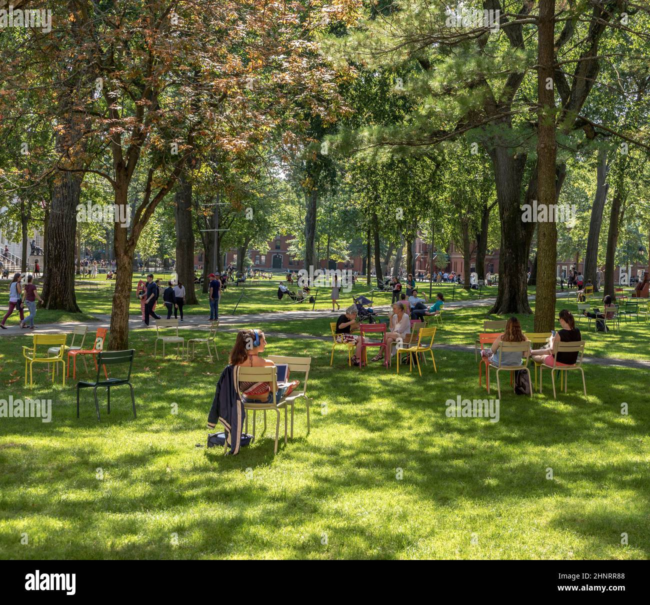 Students and tourists rest in lawn chairs in Harvard Yard, the open old ...