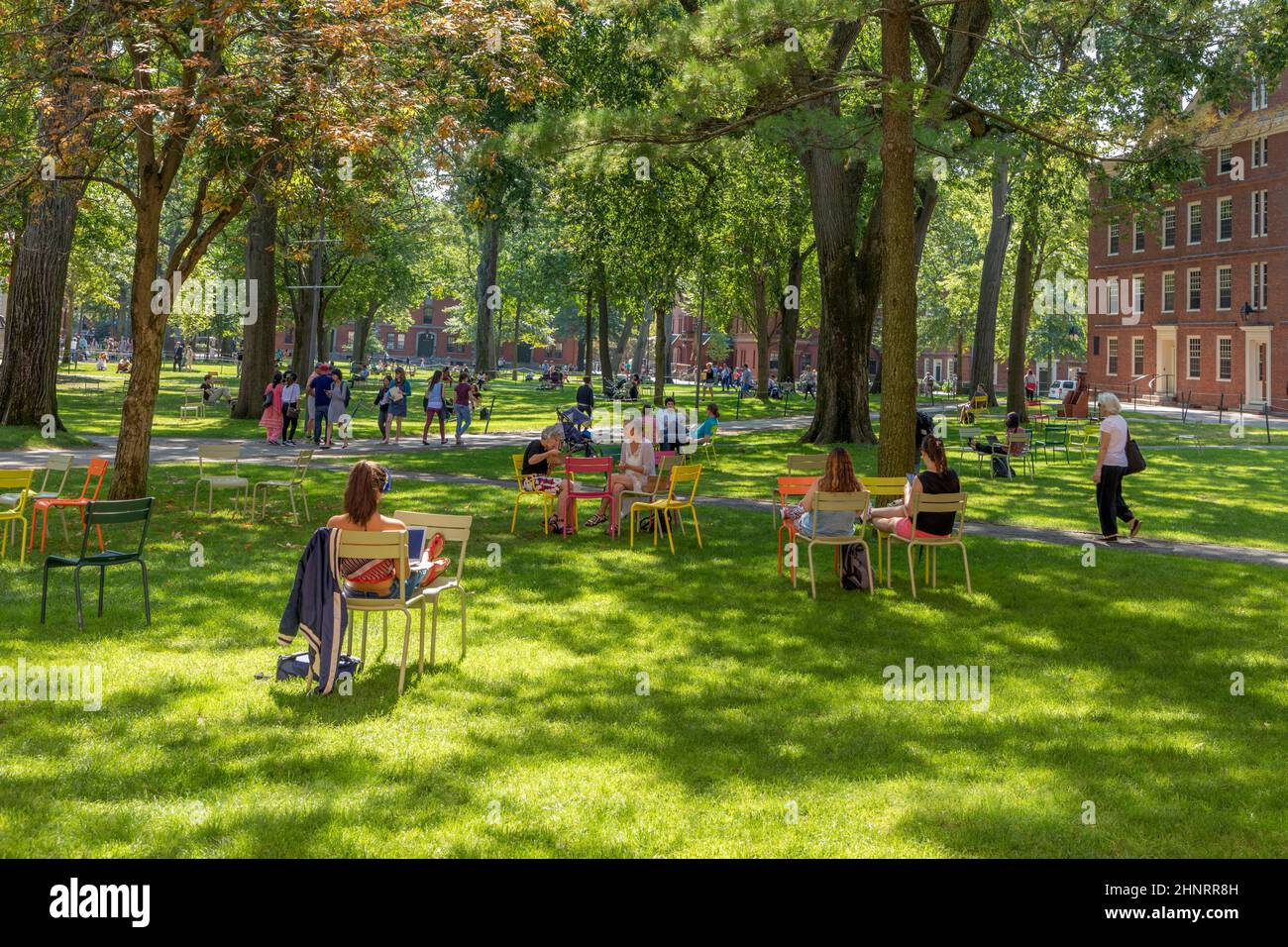 Students and tourists rest in lawn chairs in Harvard Yard, the open old ...