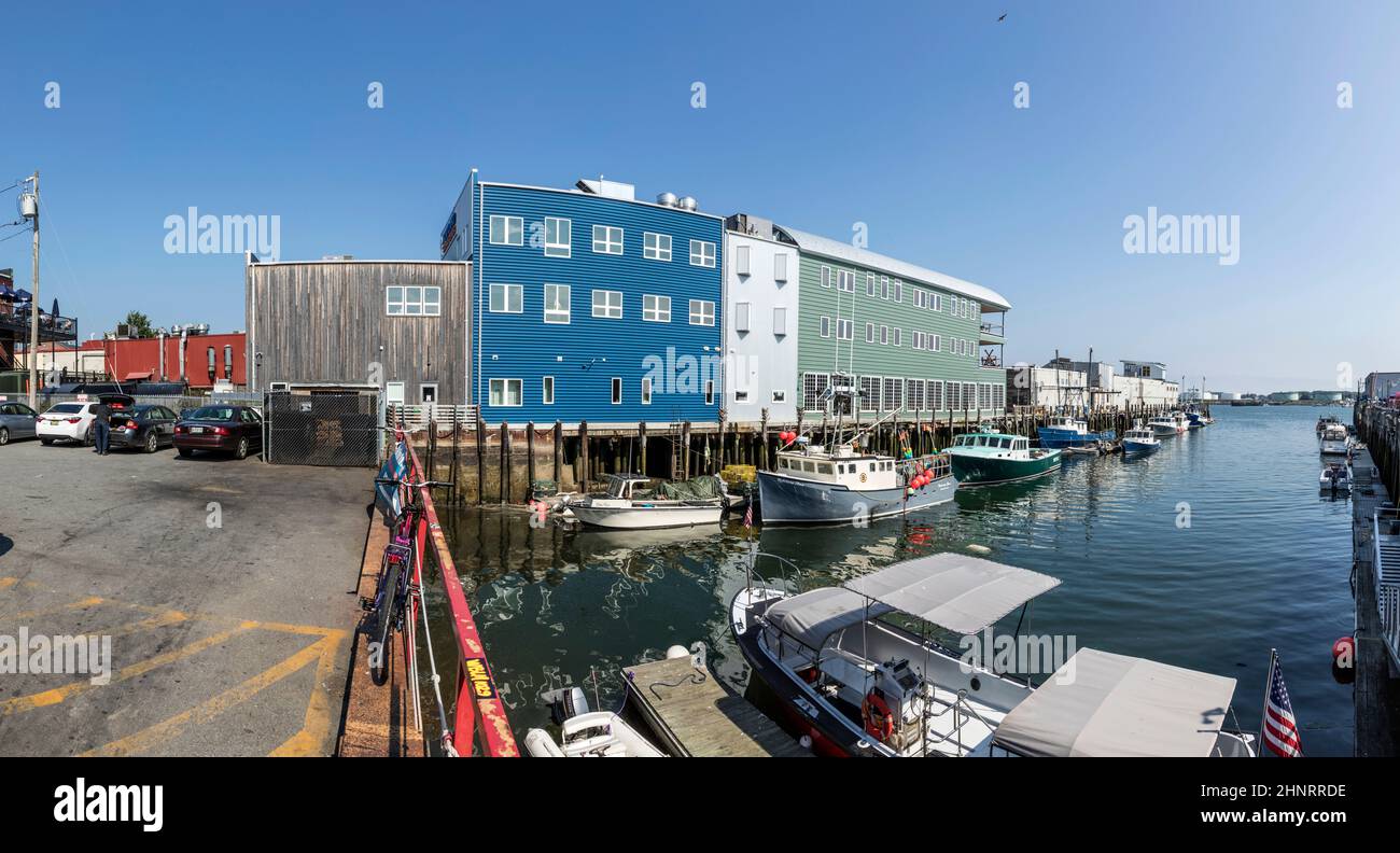 old wharf area in Portland with motorboats and old halls from fishing ...