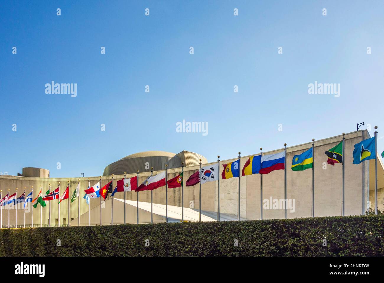 UN Nations building with flags of participating countries in afternoon ...