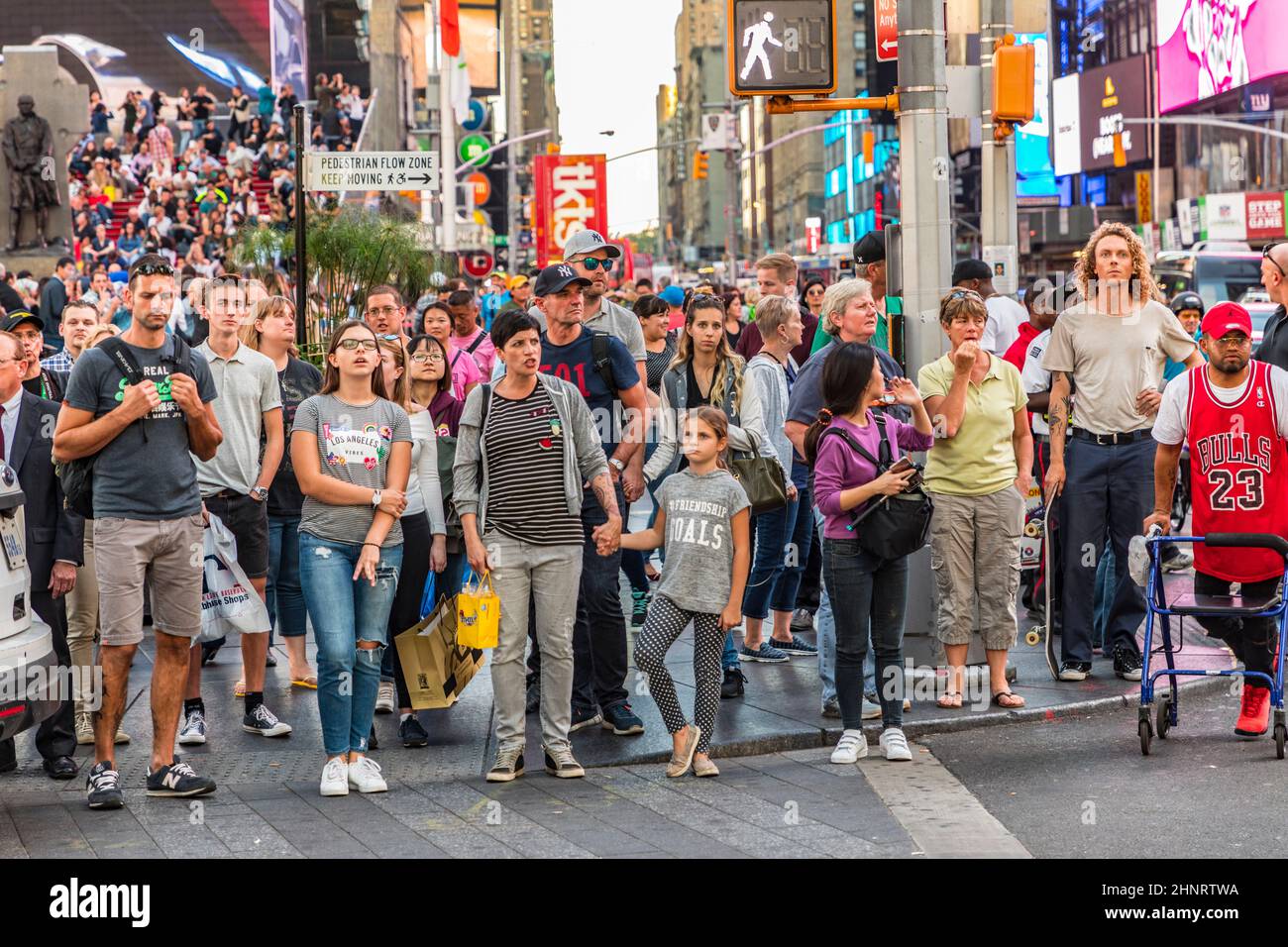 tourists and local people visit times square in late afternoon and wait ...