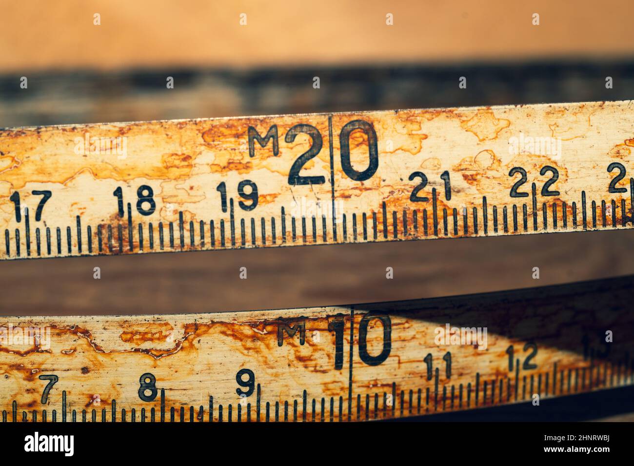 Old rusty ruler with black numbers on a working wooden table. vintage ...