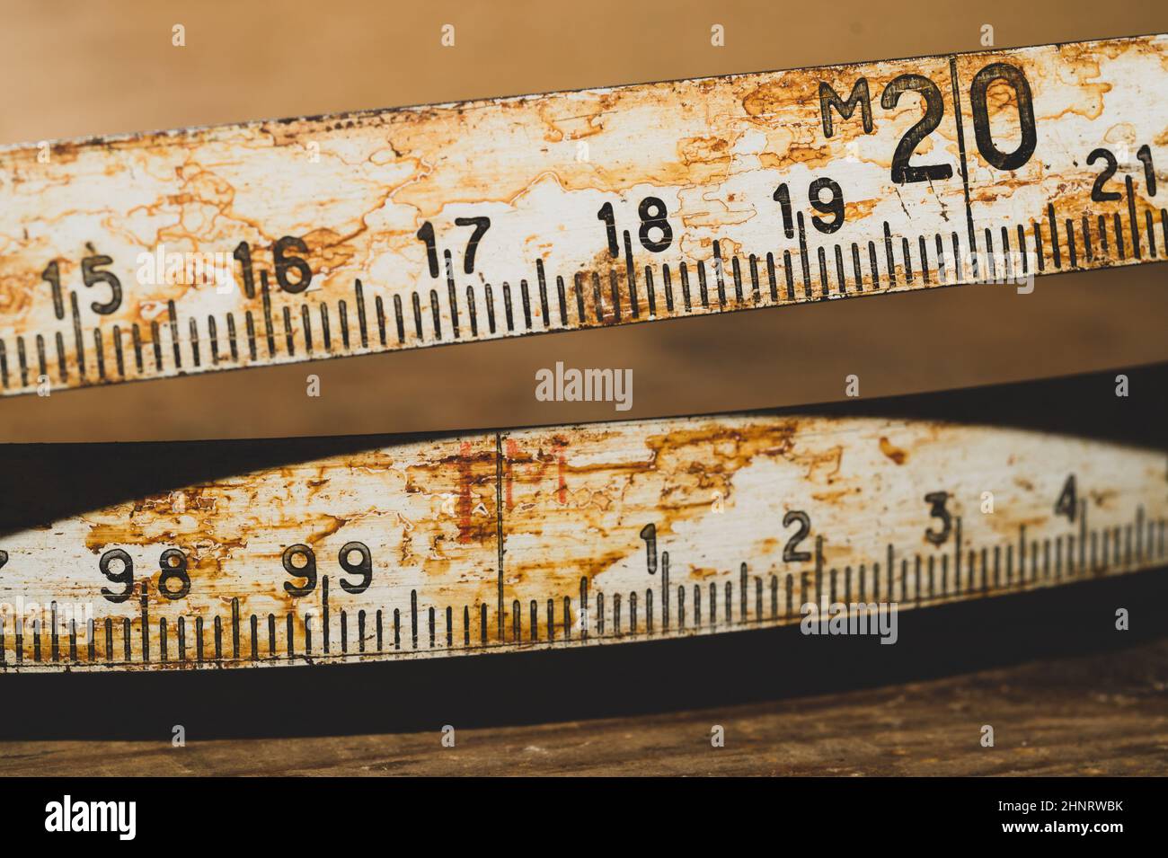 Old rusty ruler with black numbers on a working wooden table. vintage ...