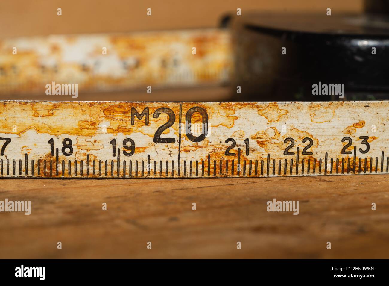 Old rusty ruler with black numbers on a working wooden table. vintage ...