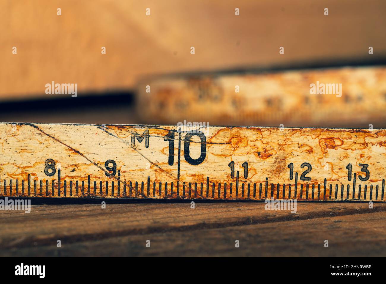Old rusty ruler with black numbers on a working wooden table. vintage ...
