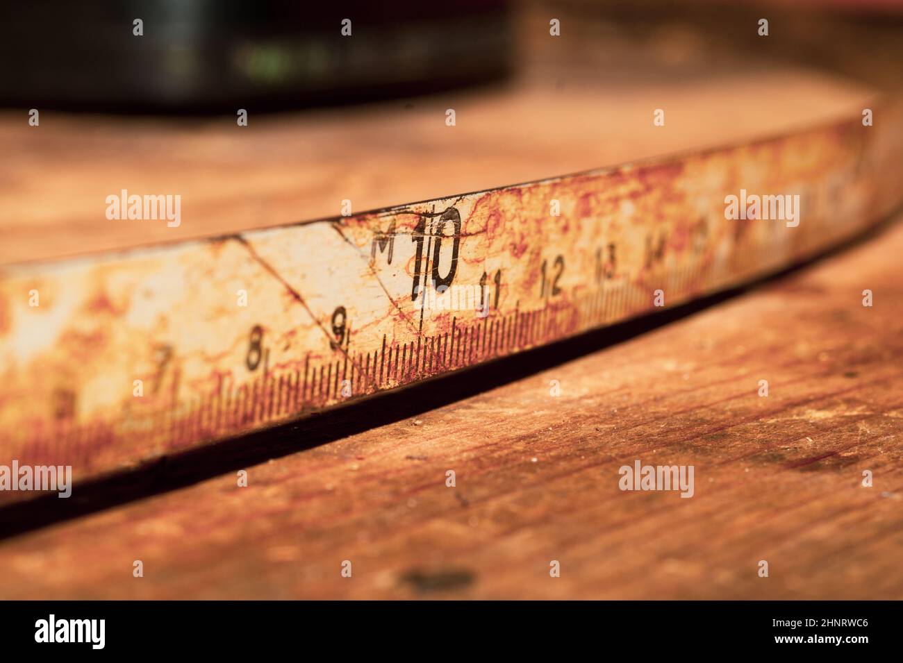 Old rusty ruler with black numbers on a working wooden table. vintage ...