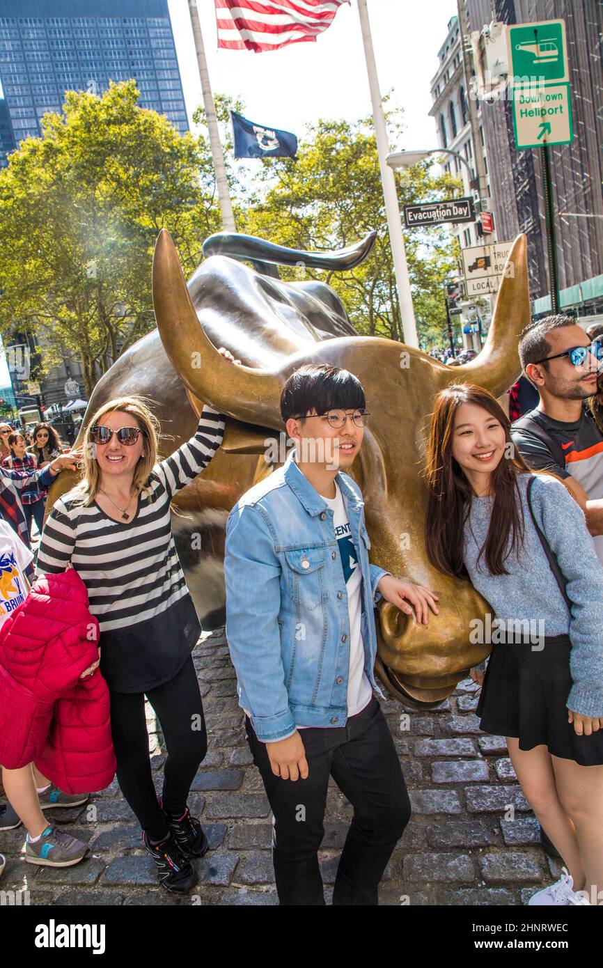 people visit charging Bull in Lower Manhattan in New York City Stock Photo - Alamy