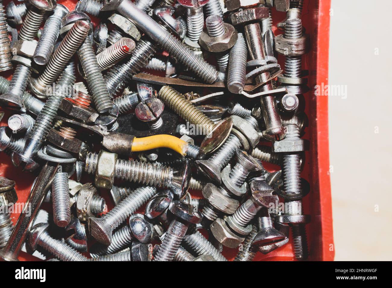 Old screws in a box. a lot of various screws. pile of fasteners in the ...