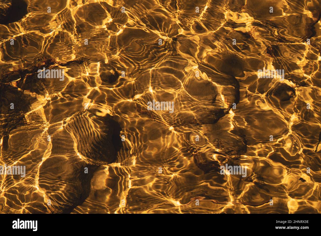 Shiny transparent water. clear water with pebbles and stone on the ...